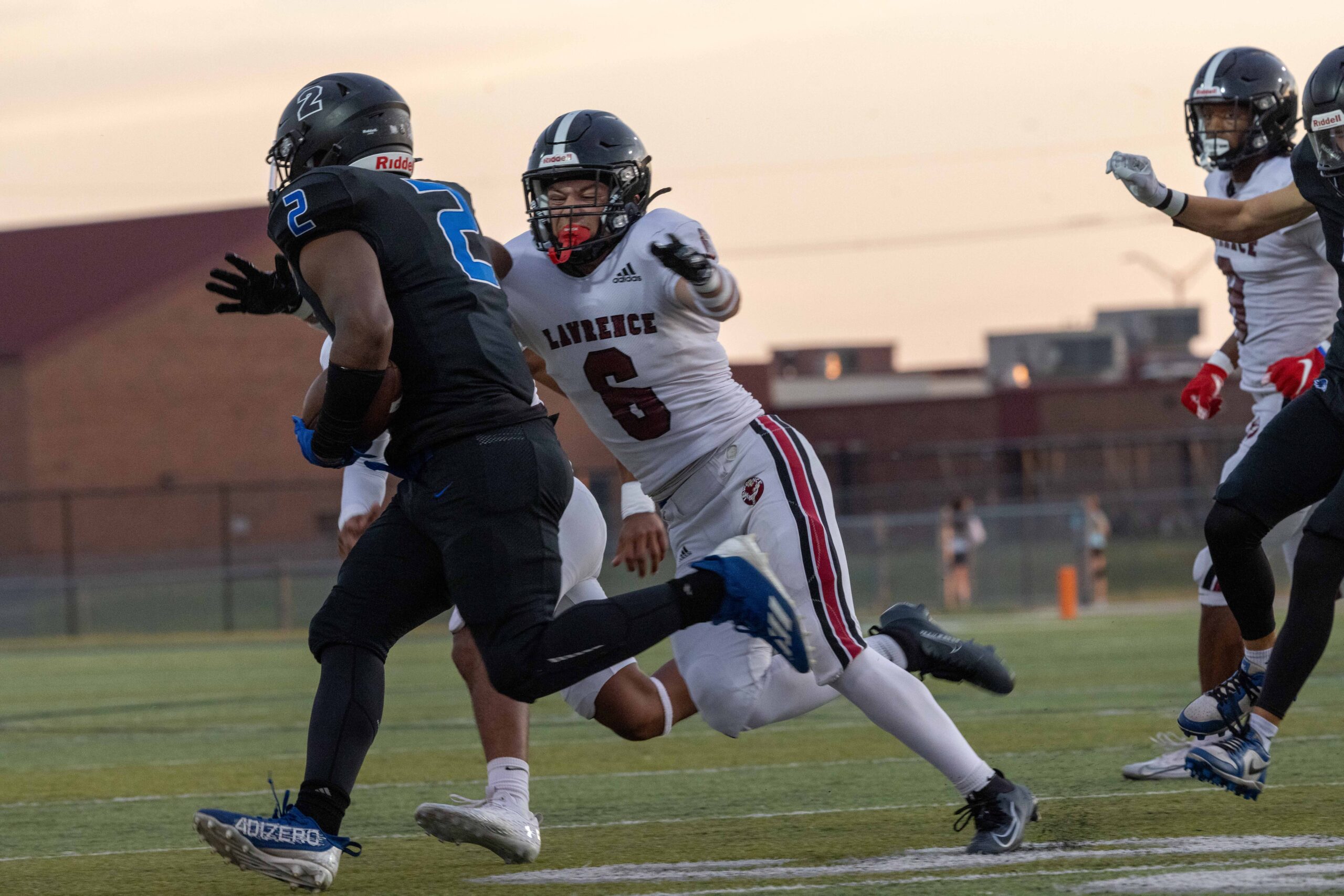 Lawrence football gets gashed in run game in 38-17 loss to Olathe ...